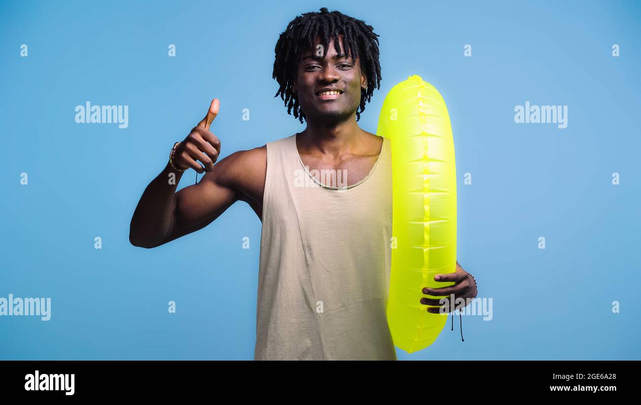 happy african american man with inflatable ring and thumb up isolated ...