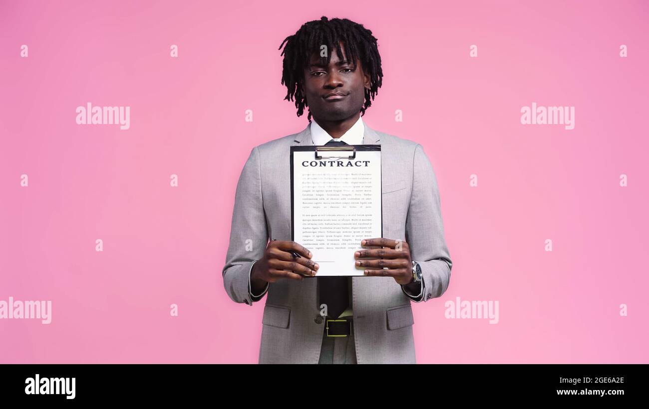 African american businessman showing contract isolated on pink Stock ...