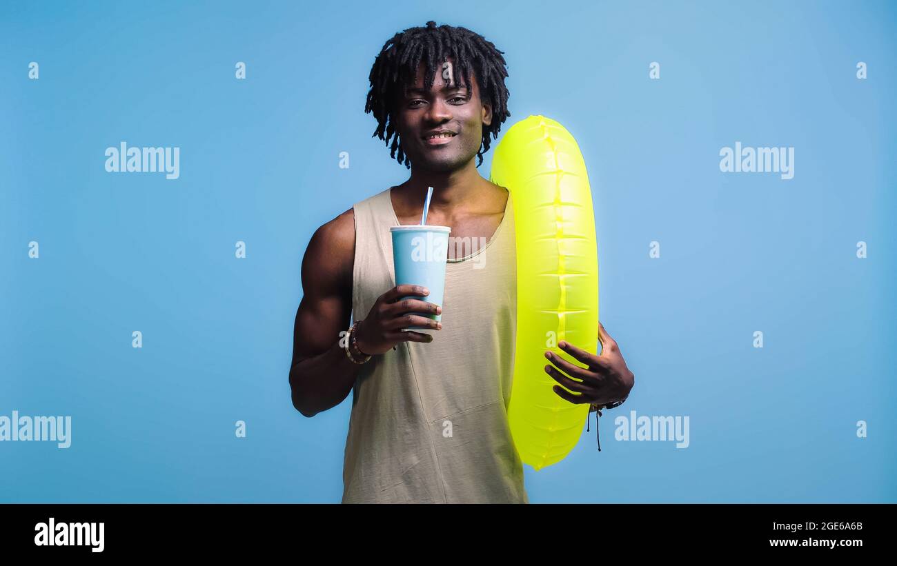 positive african american man with paper cup with soft drink and ...