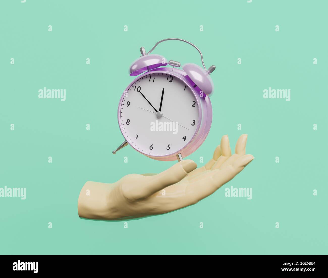 hand with an alarm clock floating above it in concept of time control ...