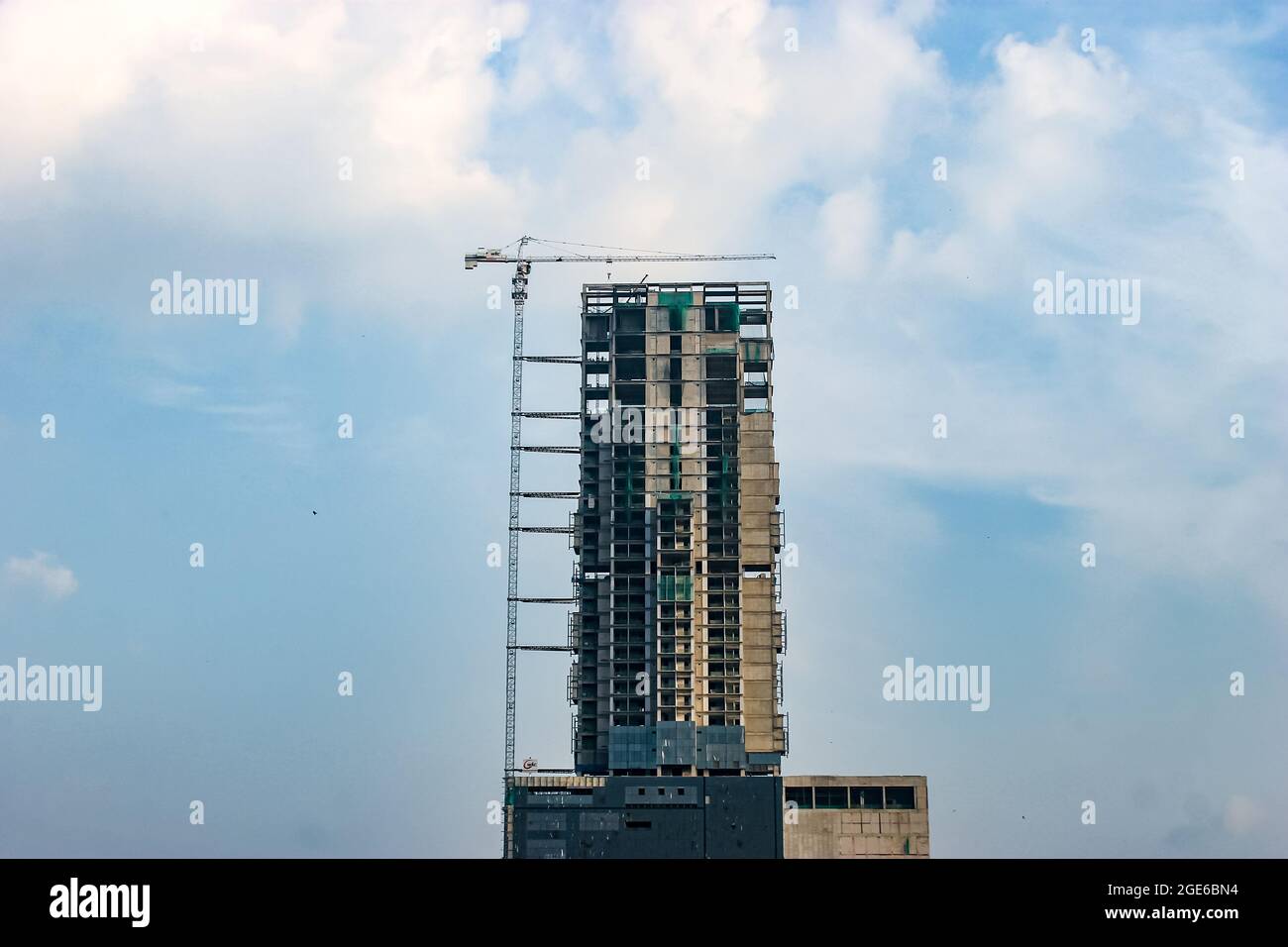 Tall building under construction with blue clouds background Stock ...