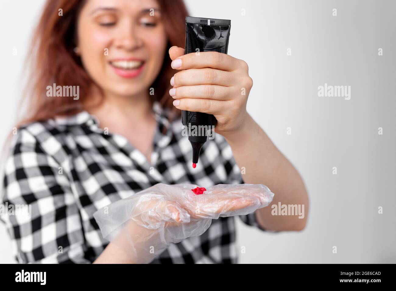 Close-up of young woman dyes her hair at home. Bright hair coloring ...