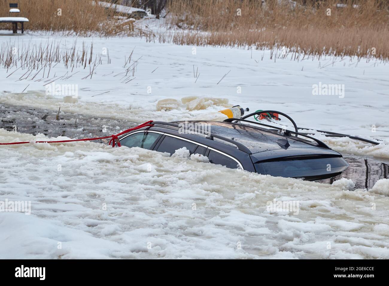 The car broke into the ice and drowned in the lake. Work of the rescue ...