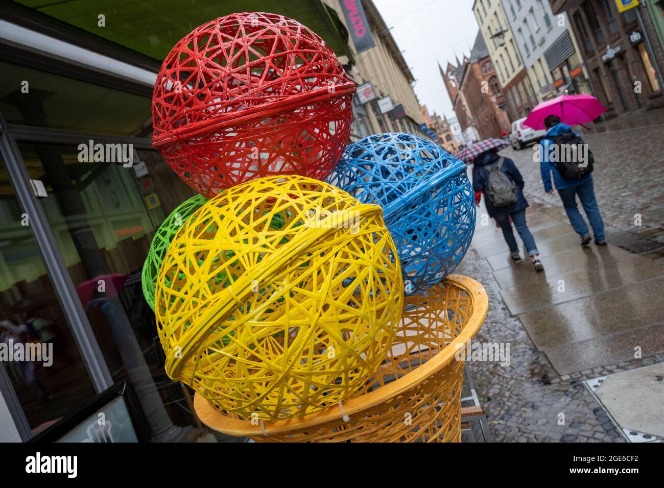 Stralsund, Germany. 17th Aug, 2021. Walkers are out in the rain in the ...