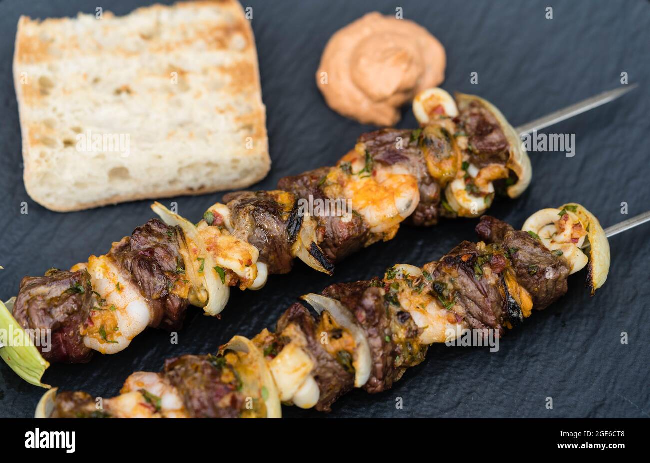 Surf and turf grilled steak and seafood on a skewer Stock Photo - Alamy