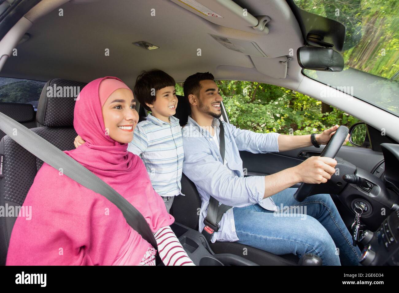 Happy Islamic Family Of Three With Little Son Driving Car Together ...