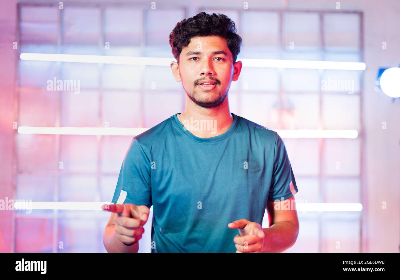 professional gamer or event manager on neon lighting stage giving ...