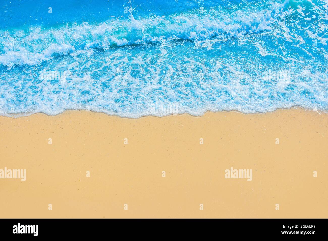 Blue seaside water on light yellow beach sand coastline seashore ...