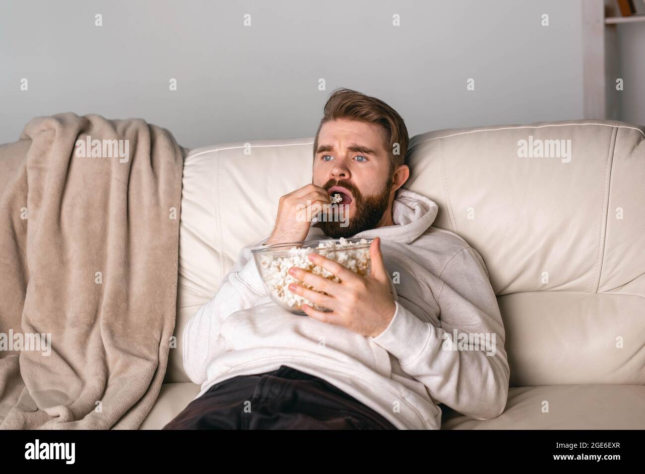 Portrait of guy watching TV series online. Online cinema and video ...