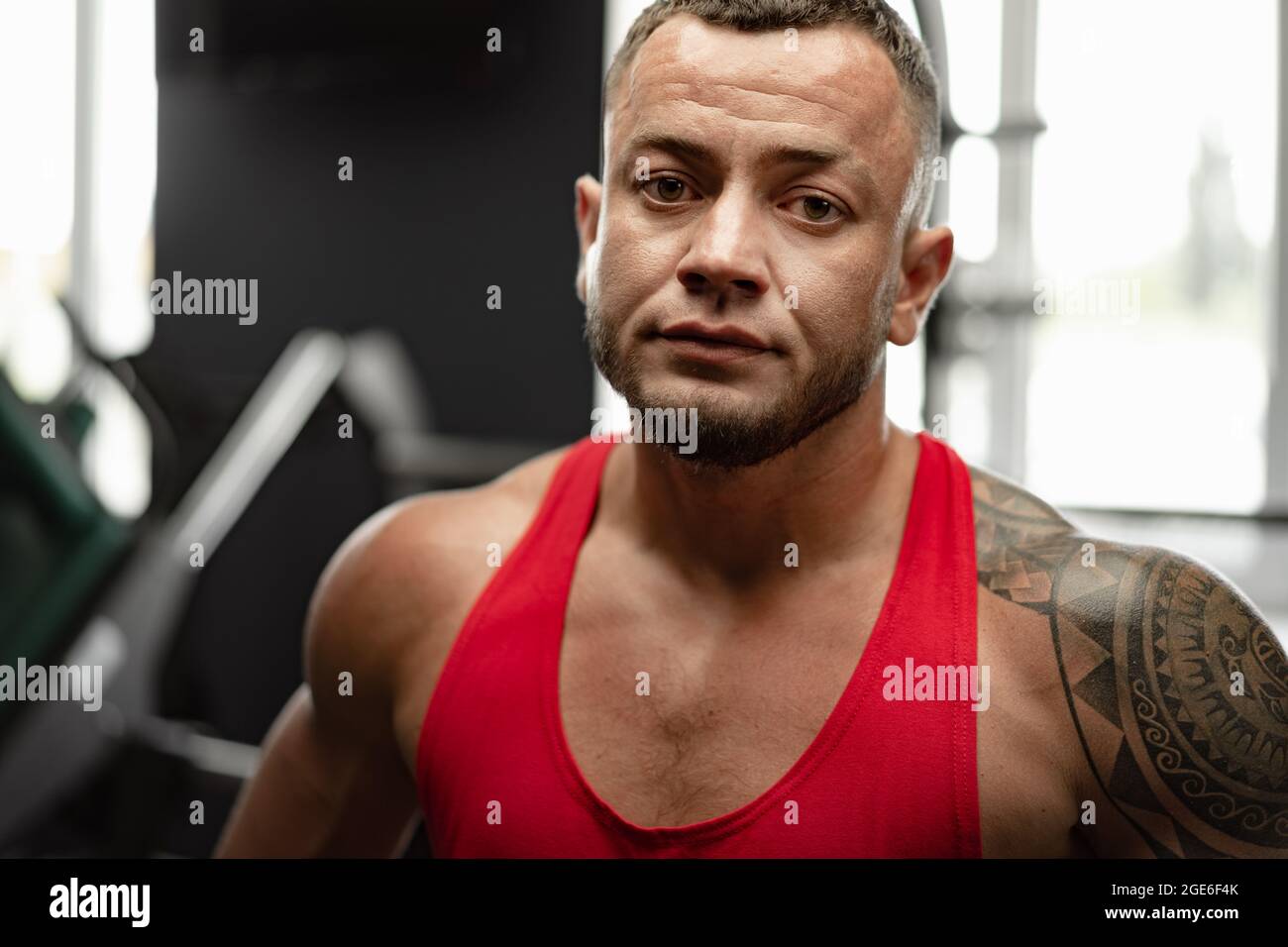 Portrait of man bodybuilder in red shirt in gym Stock Photo - Alamy