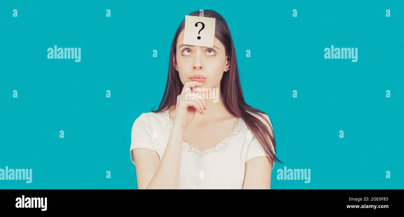 Doubtful girl asking questions to himself. Paper notes with question ...