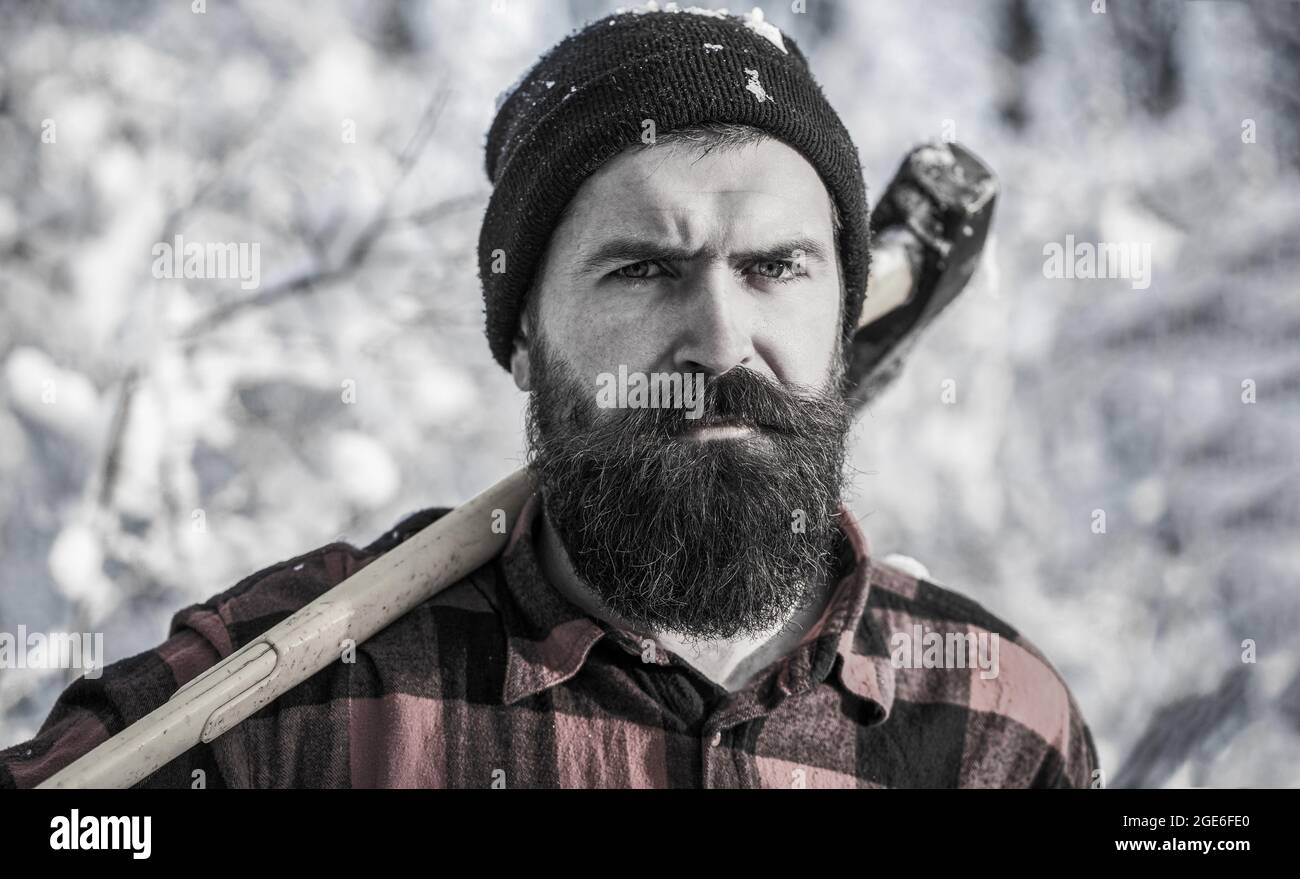 Lumberjack in the woods with an ax. Brutal bearded man with beard and ...