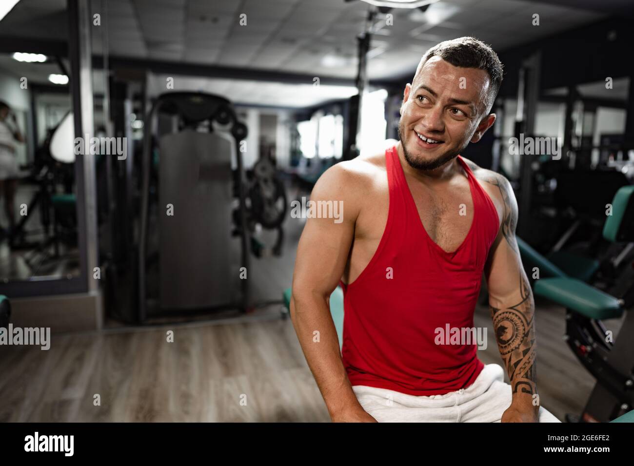 Portrait of man bodybuilder in red shirt in gym Stock Photo - Alamy