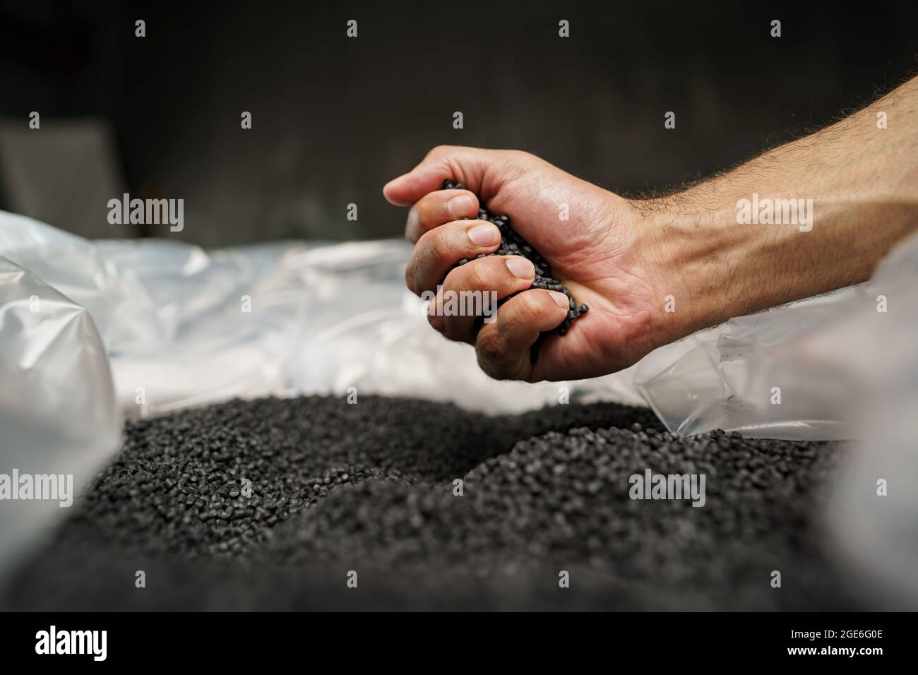 Close up of male hand holding plastic polymer granules Stock Photo - Alamy