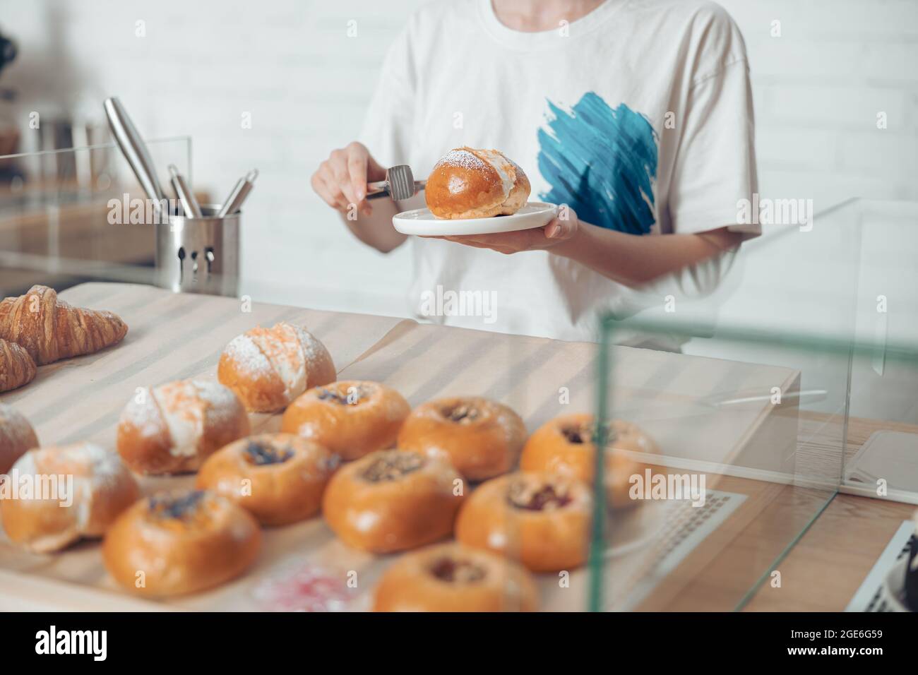Woman placing food on plate hi-res stock photography and images - Alamy