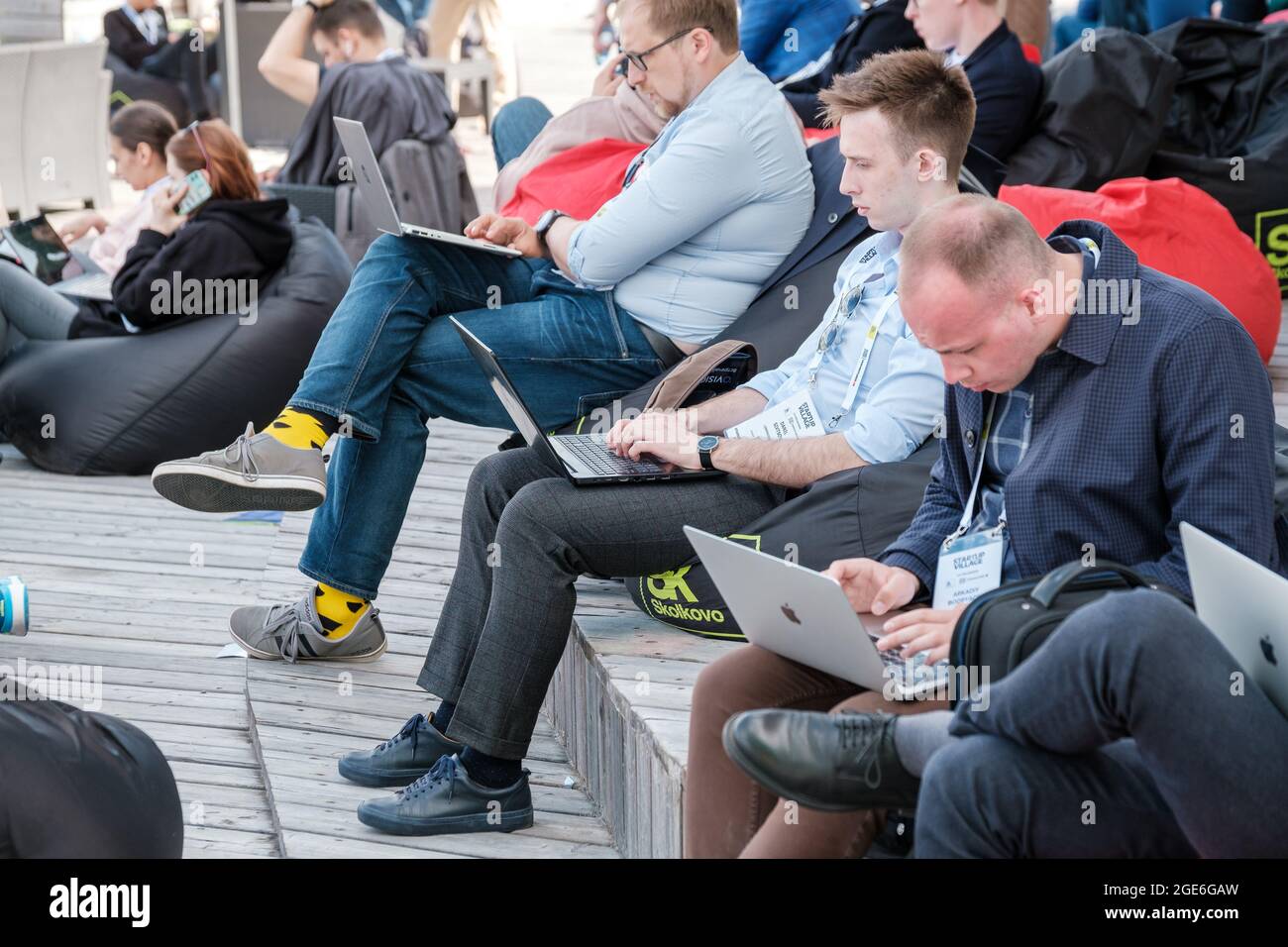 Men using laptops during outdoor seminar Stock Photo - Alamy