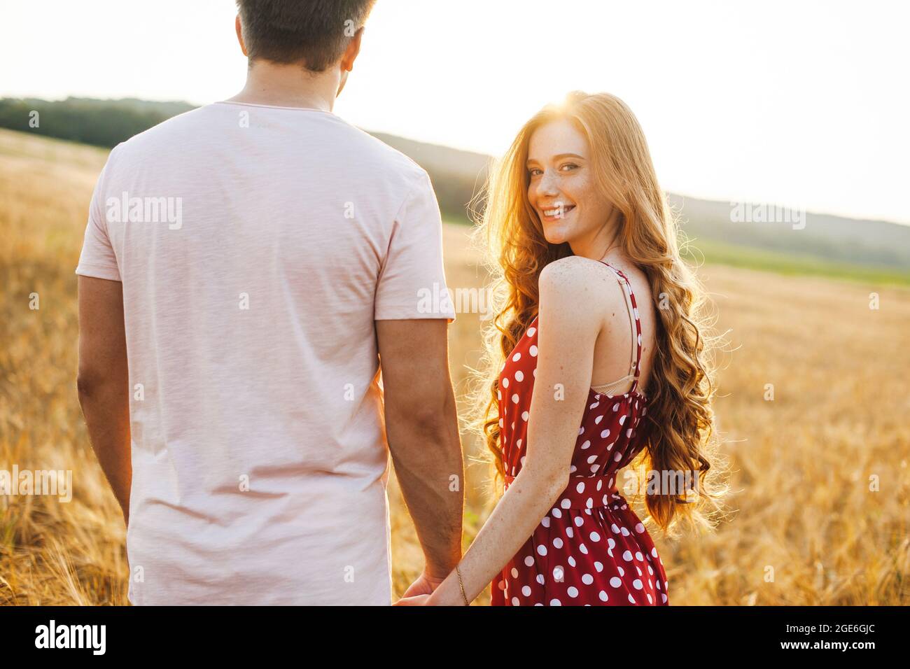 Couple photo in wheat field during sunny day in vintage style. Romantic ...