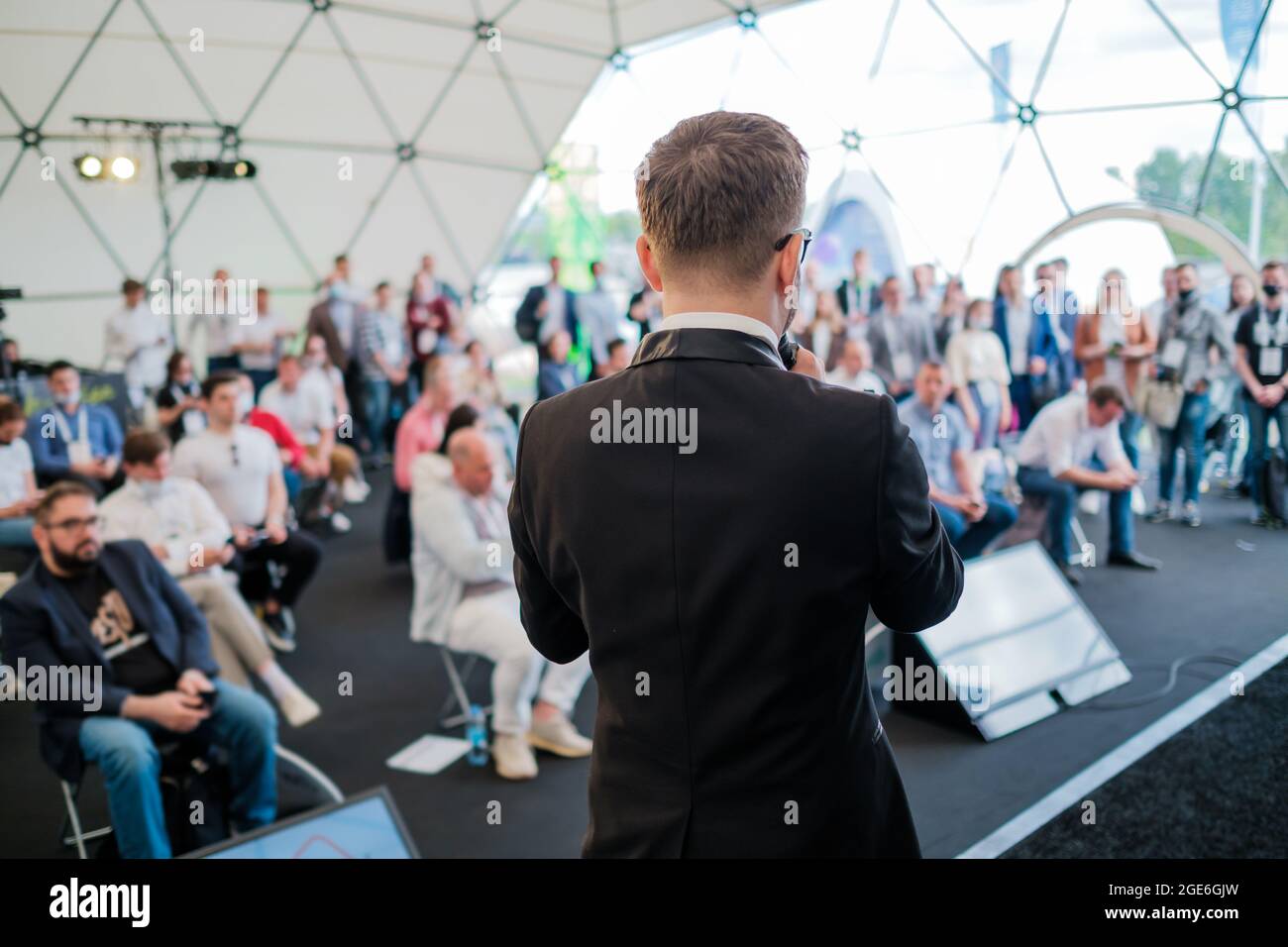 Male presenter speaks to audience Stock Photo - Alamy