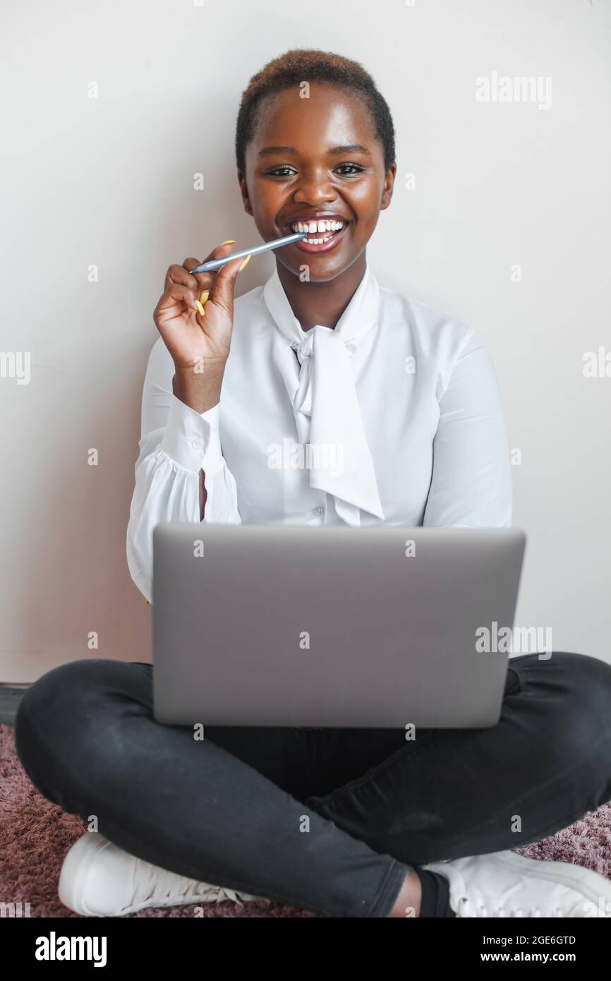 Woman suing laptop on floor for business, great design for any purposes ...