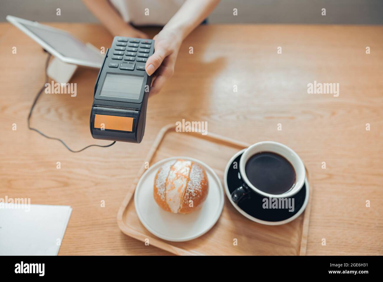 Female hand holding terminal for contactless payment Stock Photo - Alamy