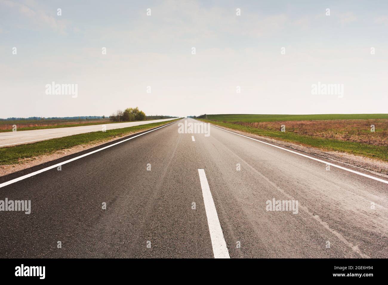 Beautiful road. Background. Road and field Stock Photo - Alamy