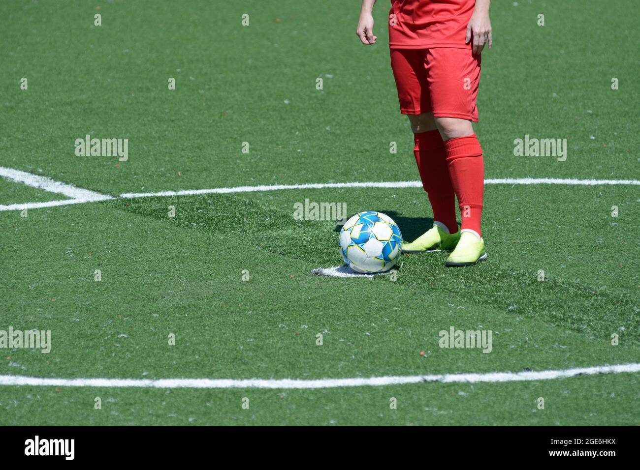 Girl football player standing in front of the soccer ball placed in the ...