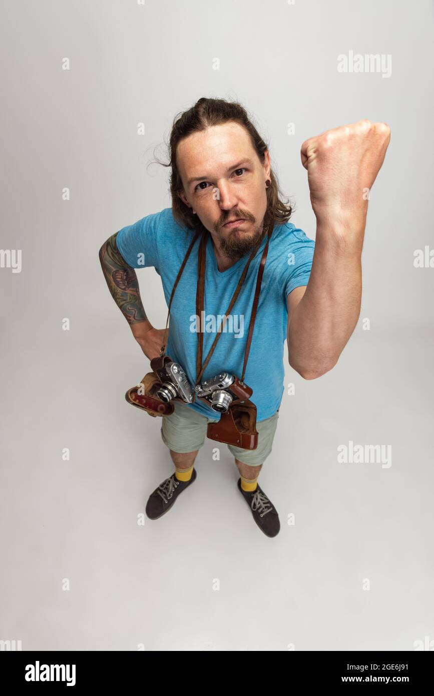 High angle view of young man, photographer, cameraman with retro camera ...