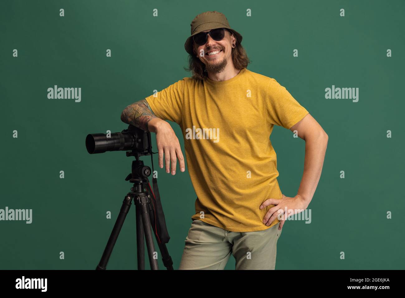 Comic portrait of young man, photographer, cameraman with retro camera ...