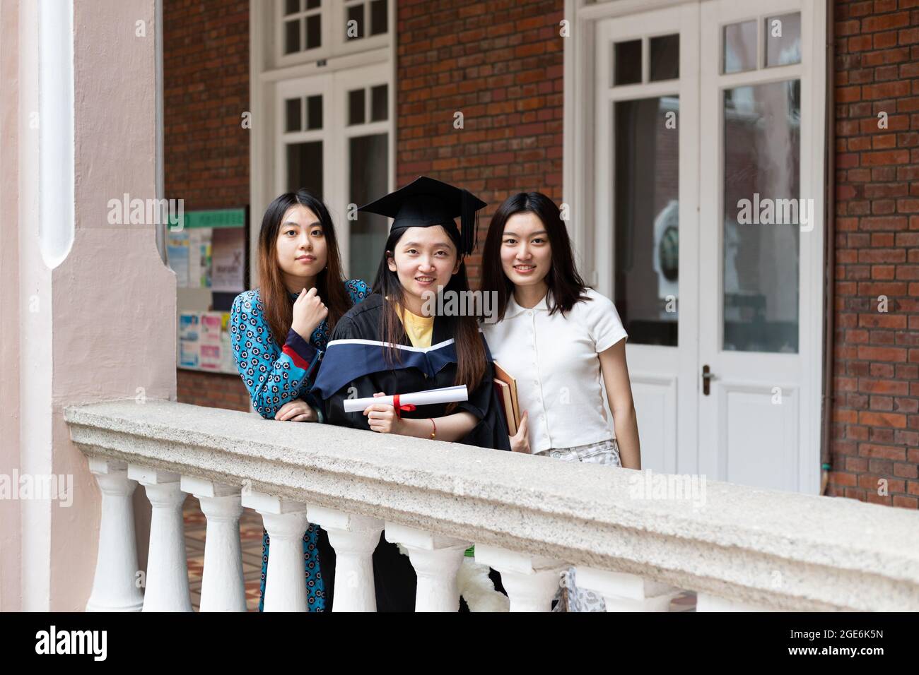 happy and cheerful Female university graduate students in academic ...