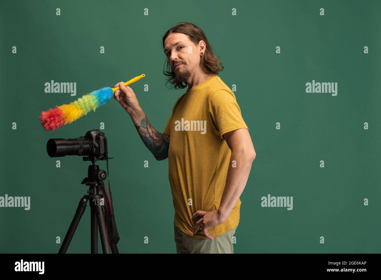 Comic portrait of young man, photographer, cameraman with retro camera ...