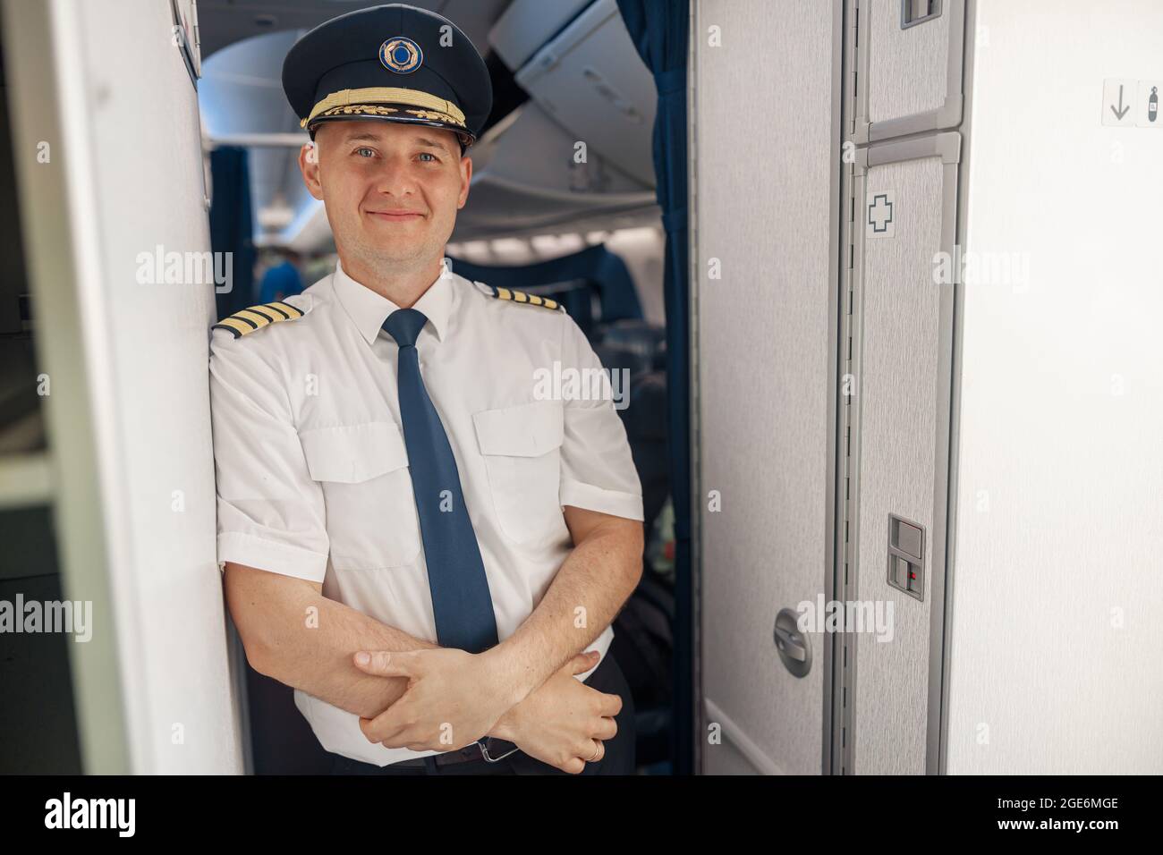 Smiling male pilot standing airplane hi-res stock photography and ...