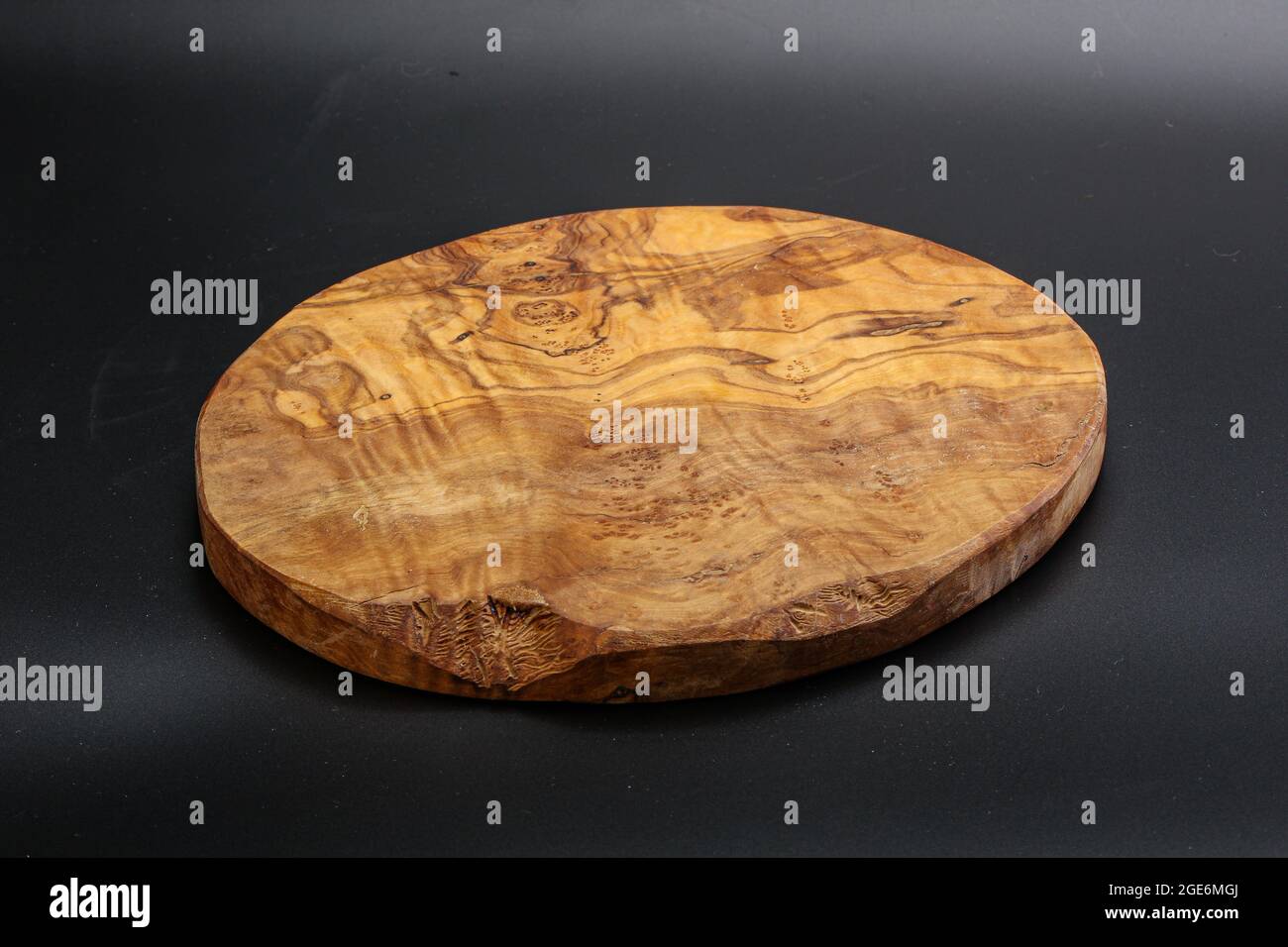 Olive tree board for kitchen over black background Stock Photo - Alamy
