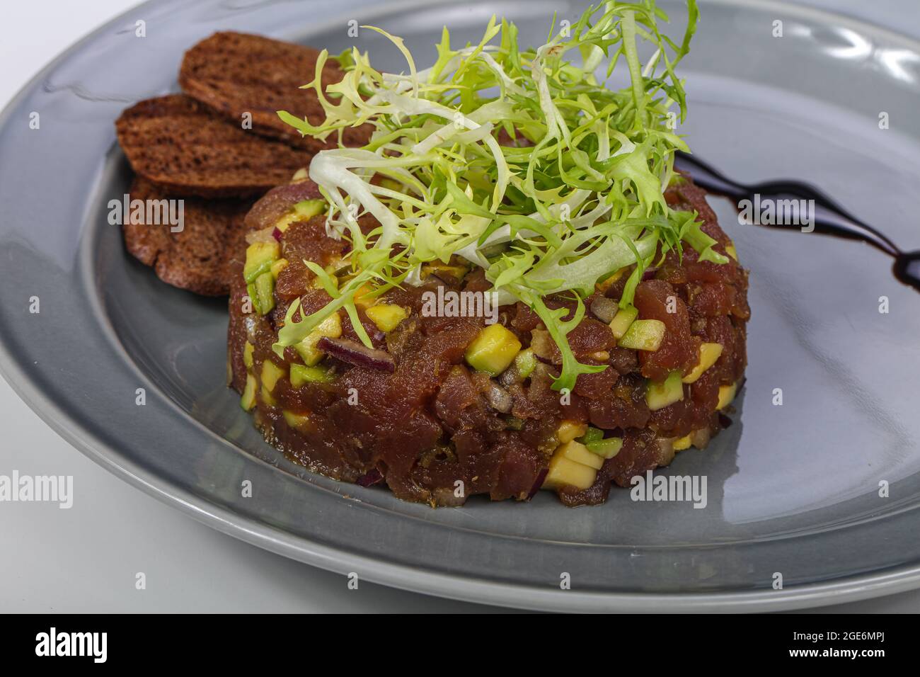 Raw Tuna fish Tartar snack with spices Stock Photo - Alamy
