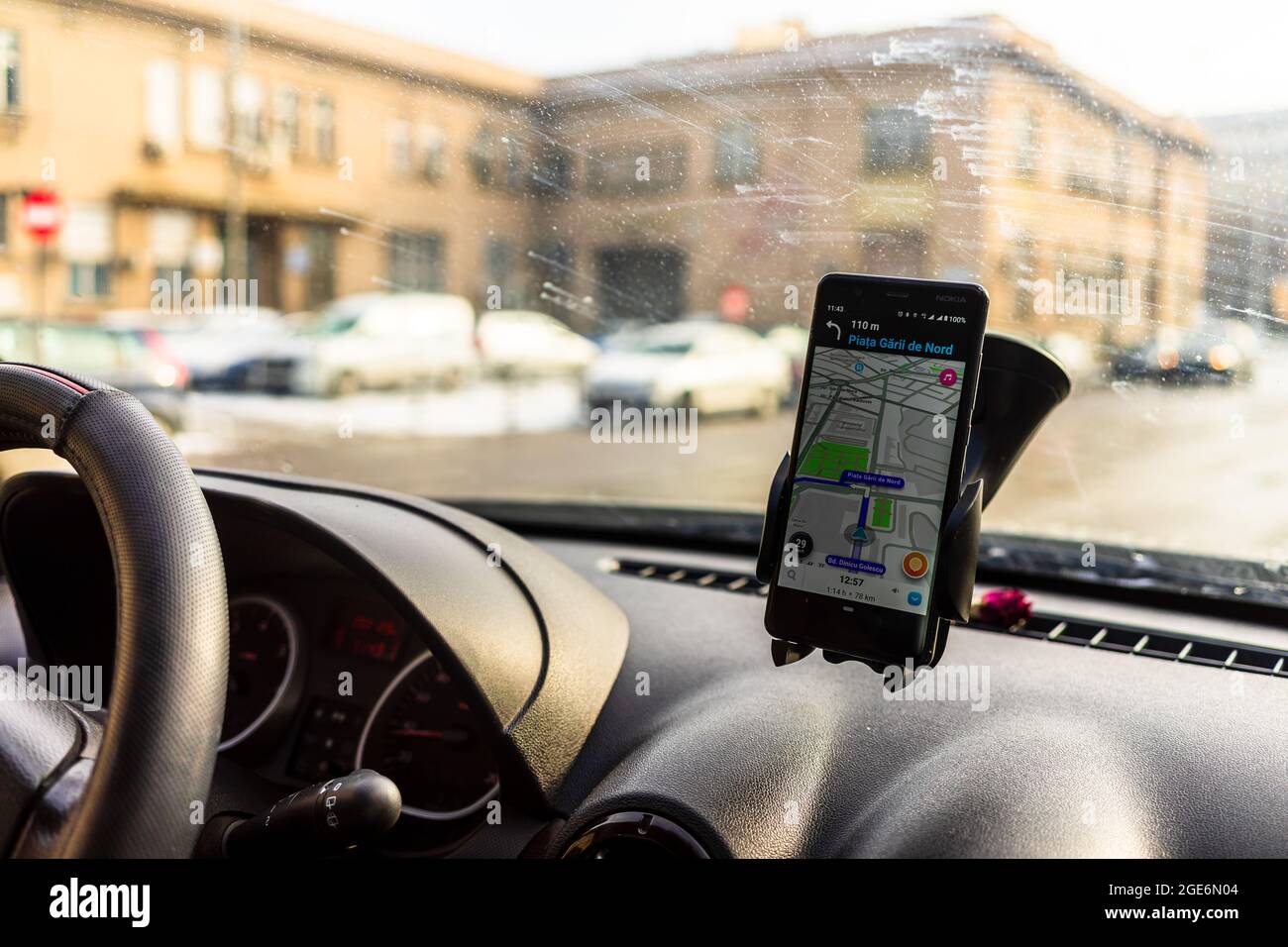 Using waze maps application on smartphone in car dashboard. Driver ...