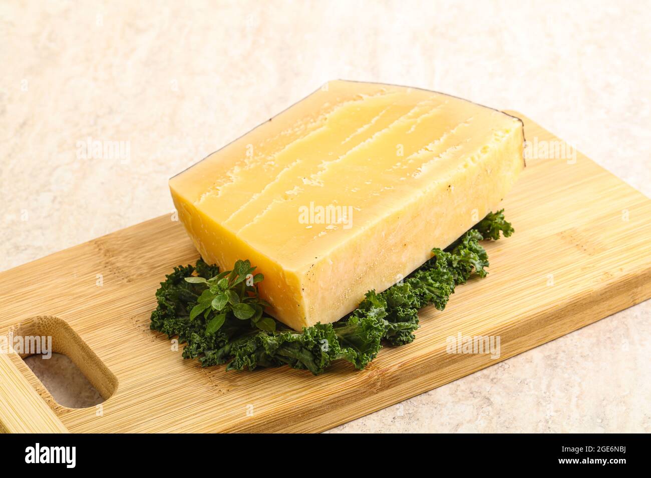 Hard Parmesan cheese piece over board Stock Photo - Alamy