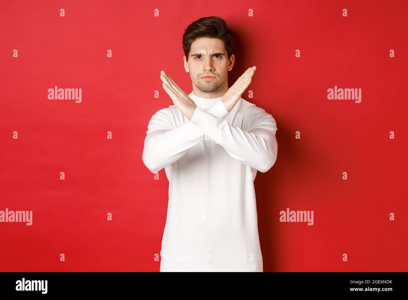 Image of serious and angry man in white sweater, express storng ...