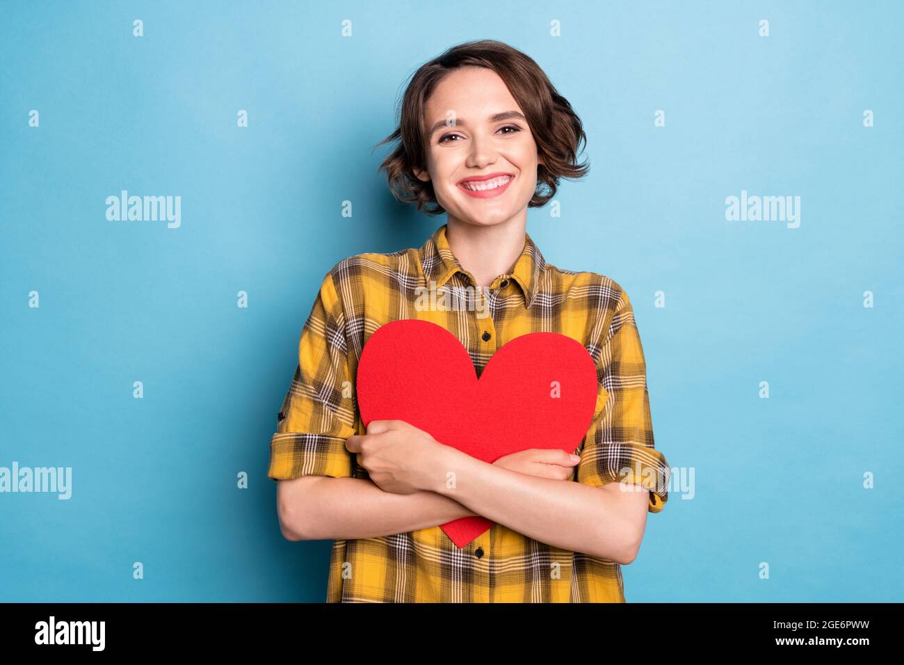 Photo of charming cheerful flirty lady cuddle heart card toothy smile ...