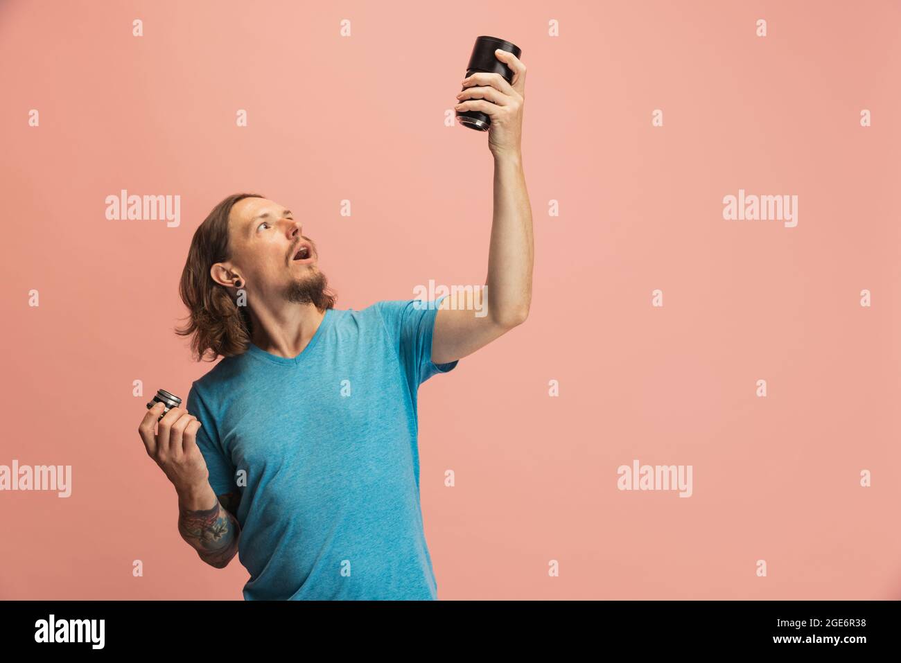 Portrait of young man, photographer, cameraman with camera lens having ...
