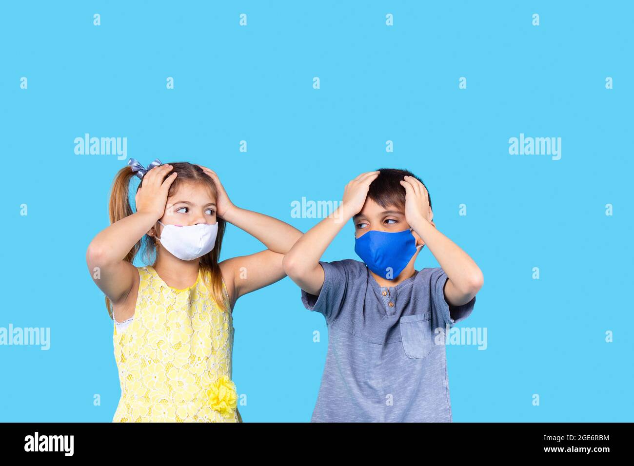 Two kids boy and girl in casual clothes wearing medical face masks use ...