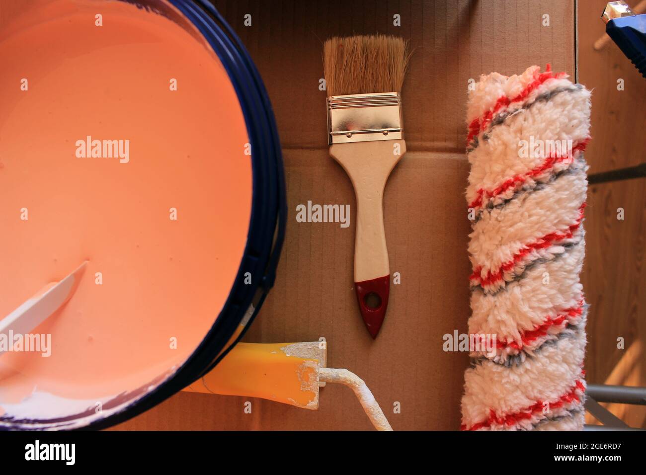 Preparing to paint the wall with brush, paint and roller brush. Top ...