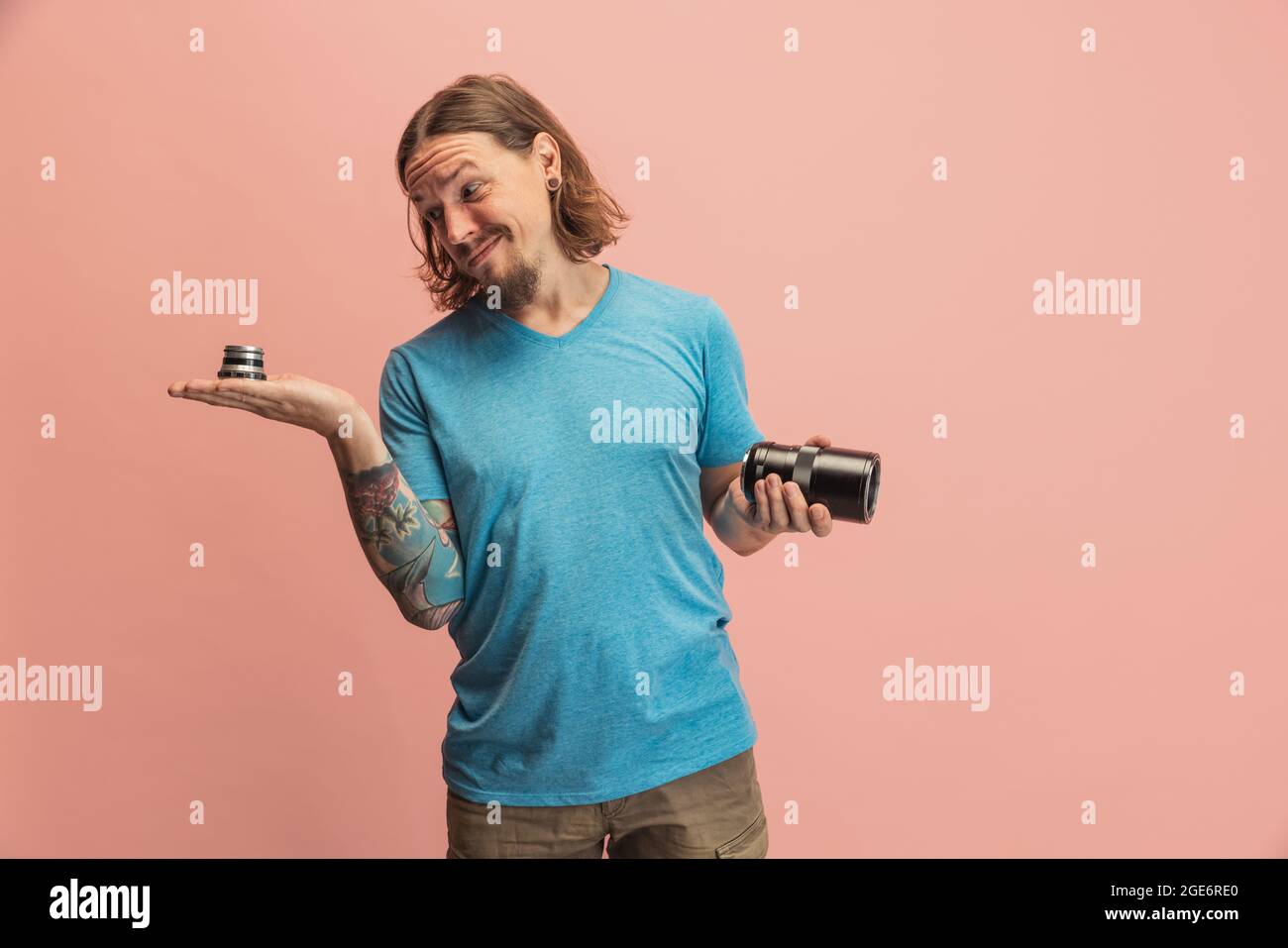 Portrait of young man, photographer, cameraman with camera lens having ...