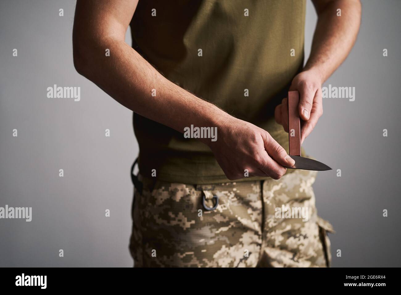 Mid-section shot of a military man sharpening his pocket knife Stock ...