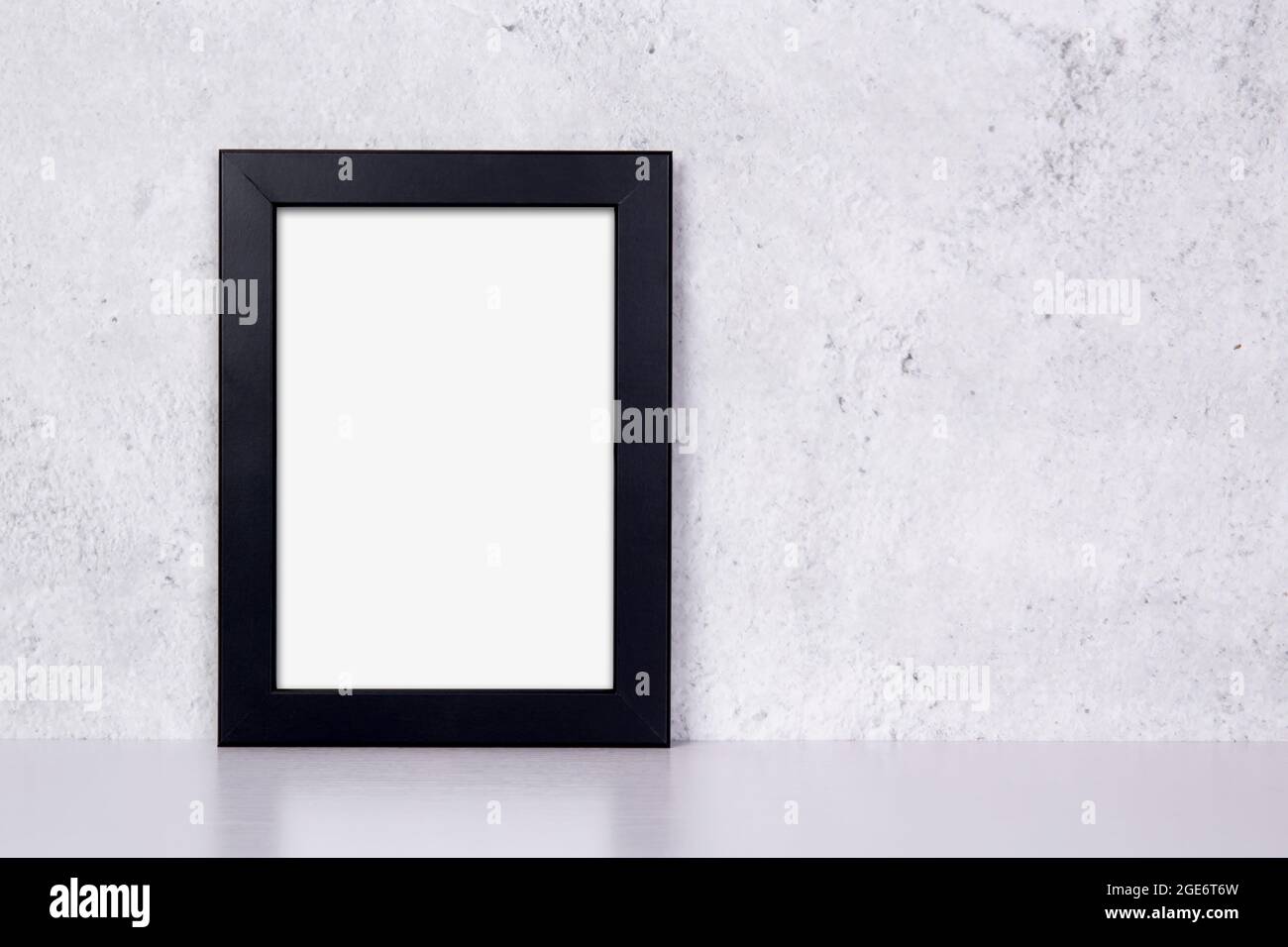 Mockup black frame vertical on table top and wall at home, mock up ...