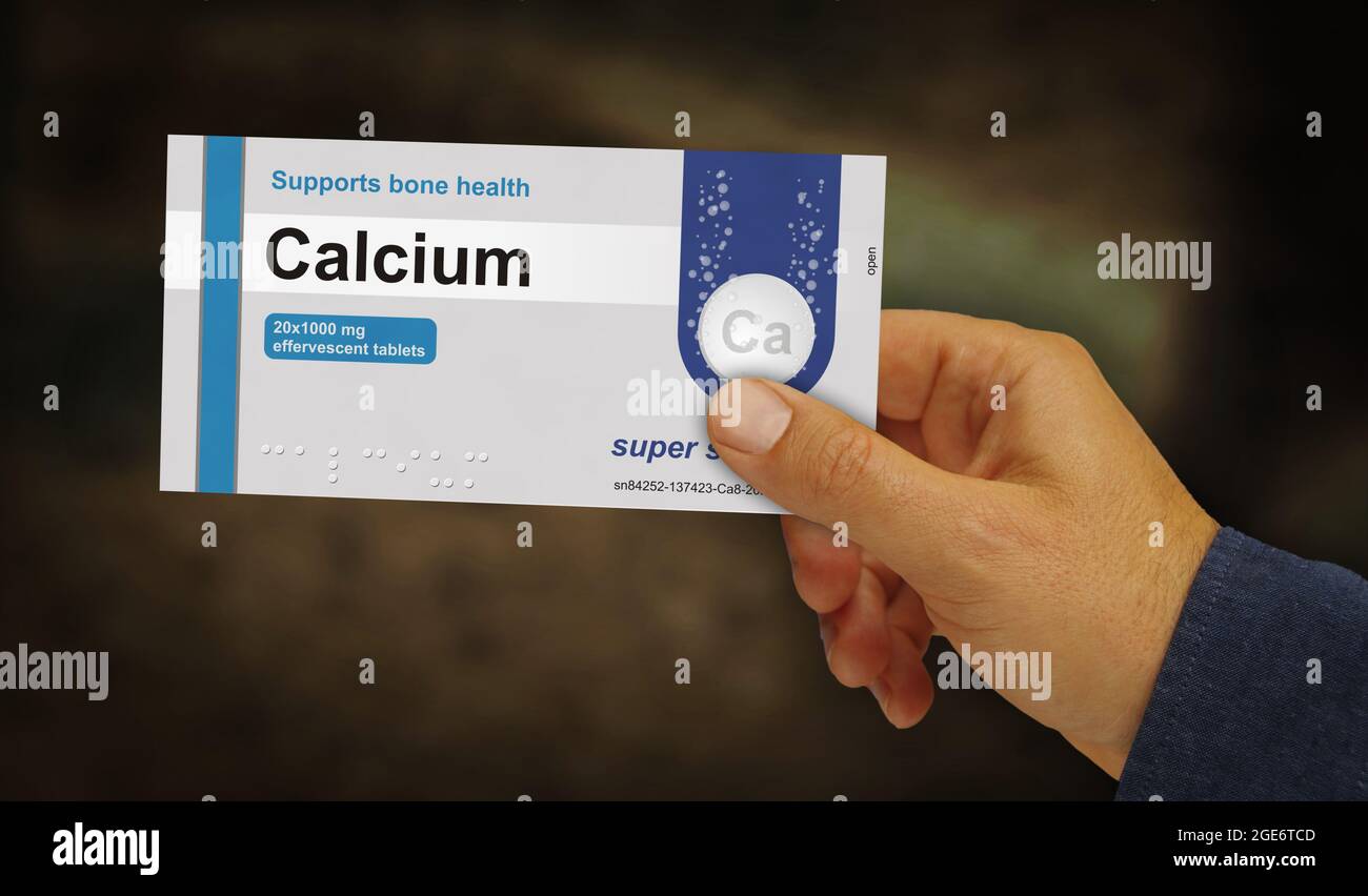 Calcium tablets box in hand. Diet supplement pills pack for bone health ...