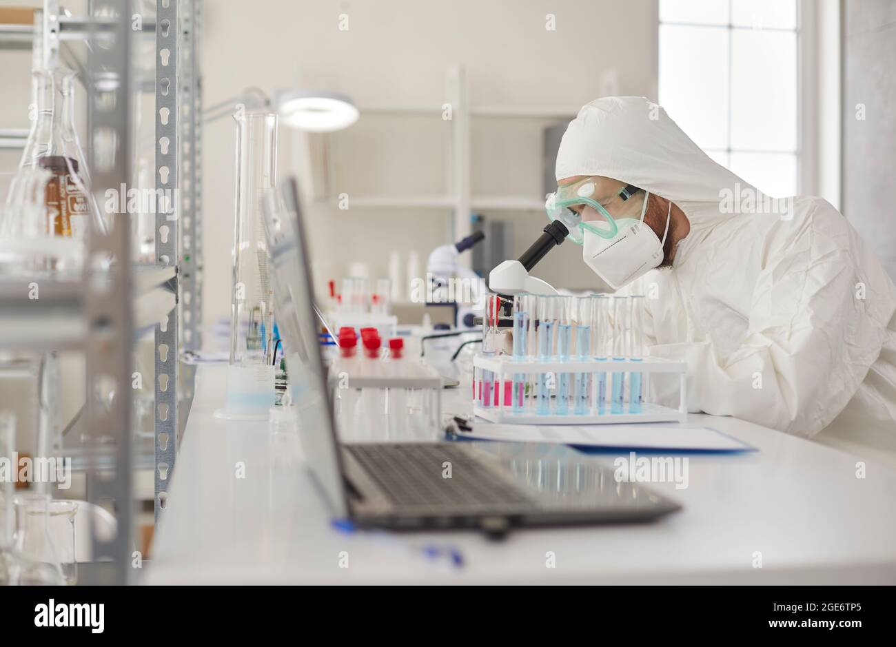 Scientist work looking in microscope hi-res stock photography and ...