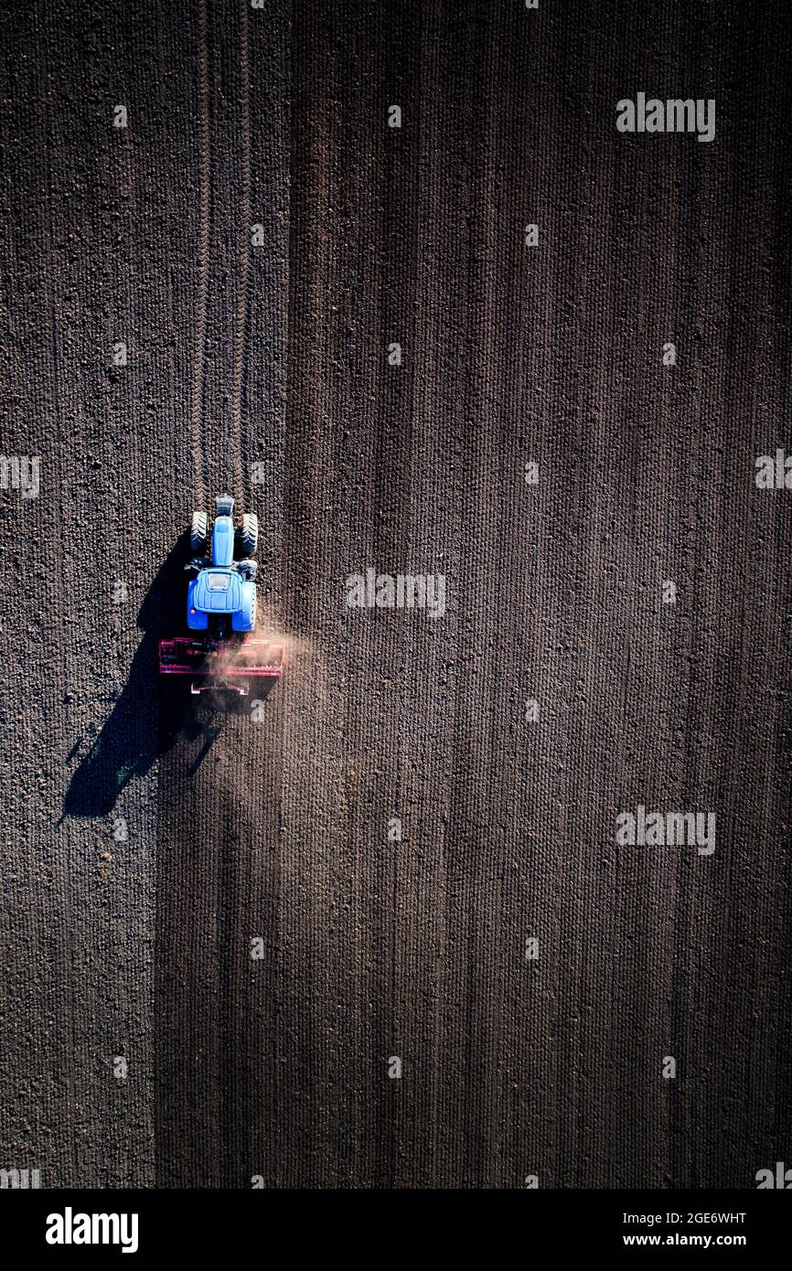 Aerial view of the mechanical preparation of a land in the autumn ...