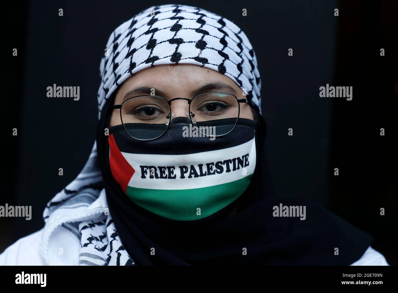 A woman wearing a "Free Palestine" mask takes part during a free ...