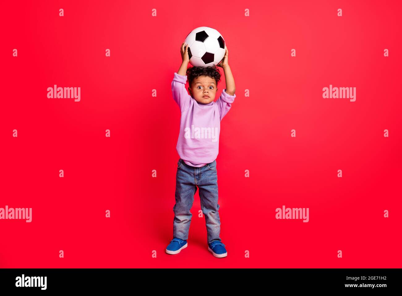 Full length body size view of attractive funny boy playing football ...