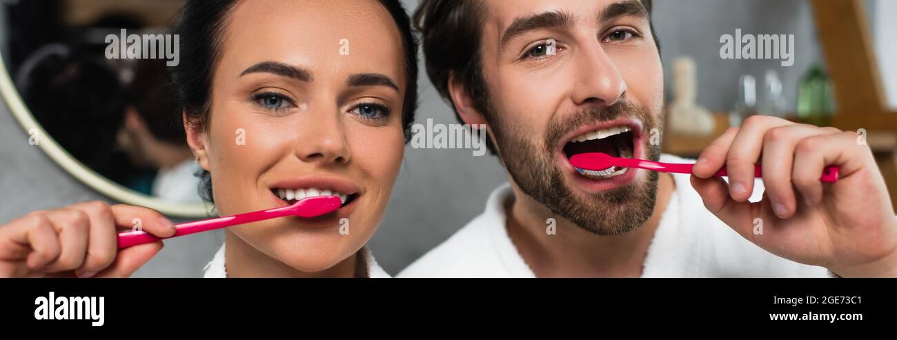 happy young couple brushing teeth, banner Stock Photo - Alamy