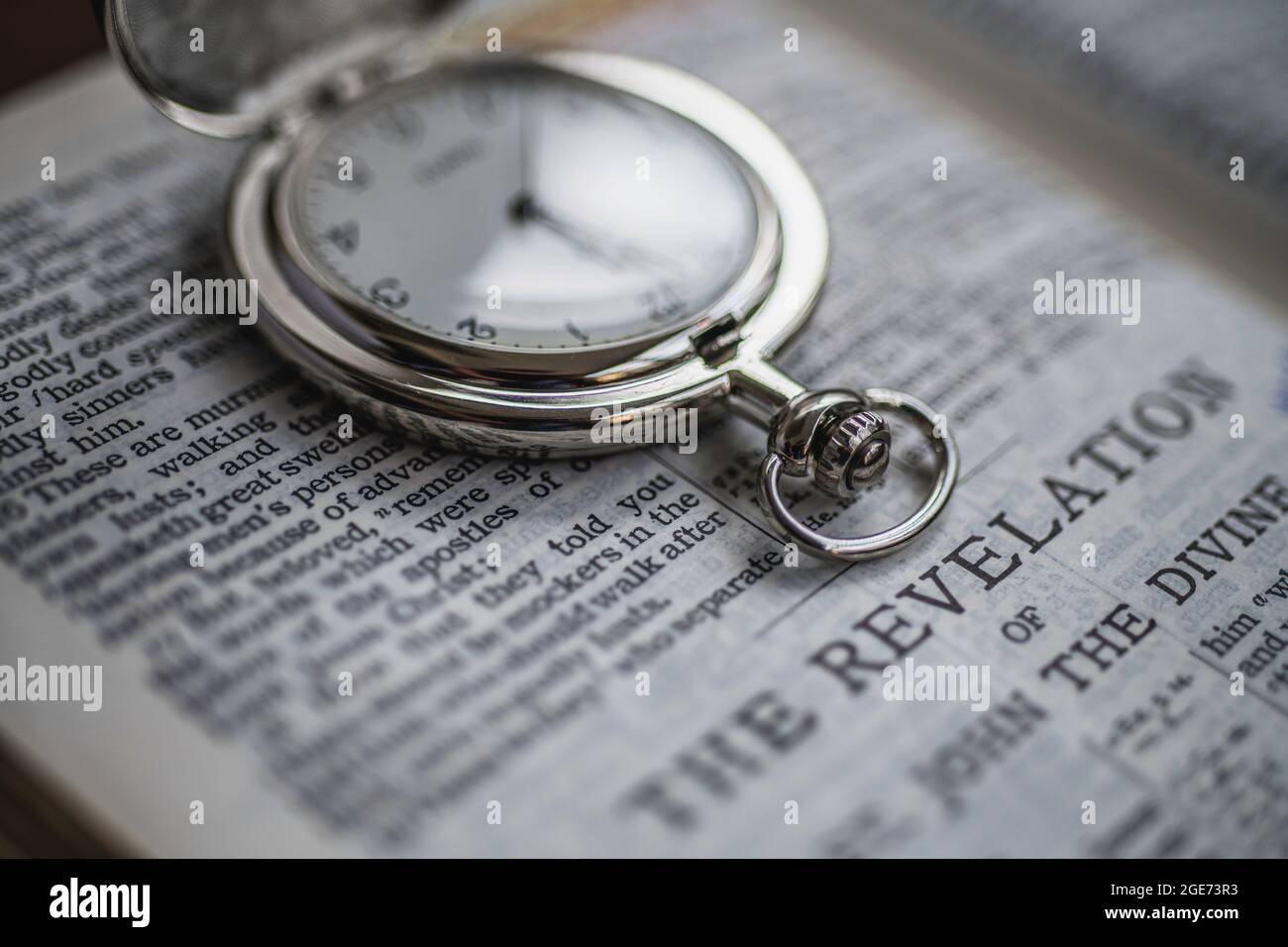 Open bible and a pocket watch Stock Photo - Alamy
